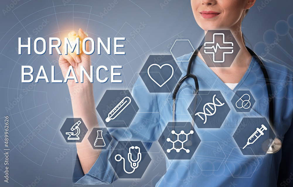 Doctor pointing at virtual screen with inscription Hormone Balance and ...
