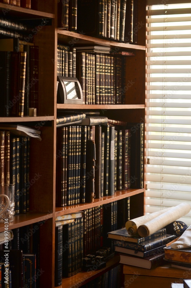 Books and Religious Jewish items in traditional wooden library with ...