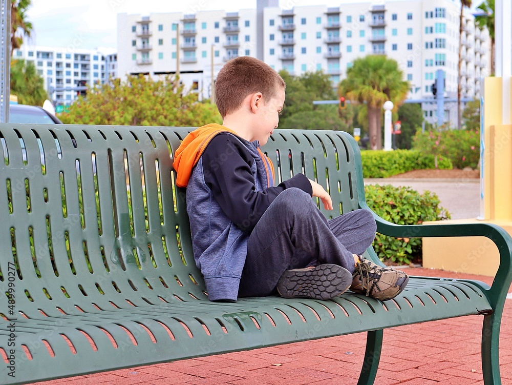 boy sitting on bench Stock Photo | Adobe Stock