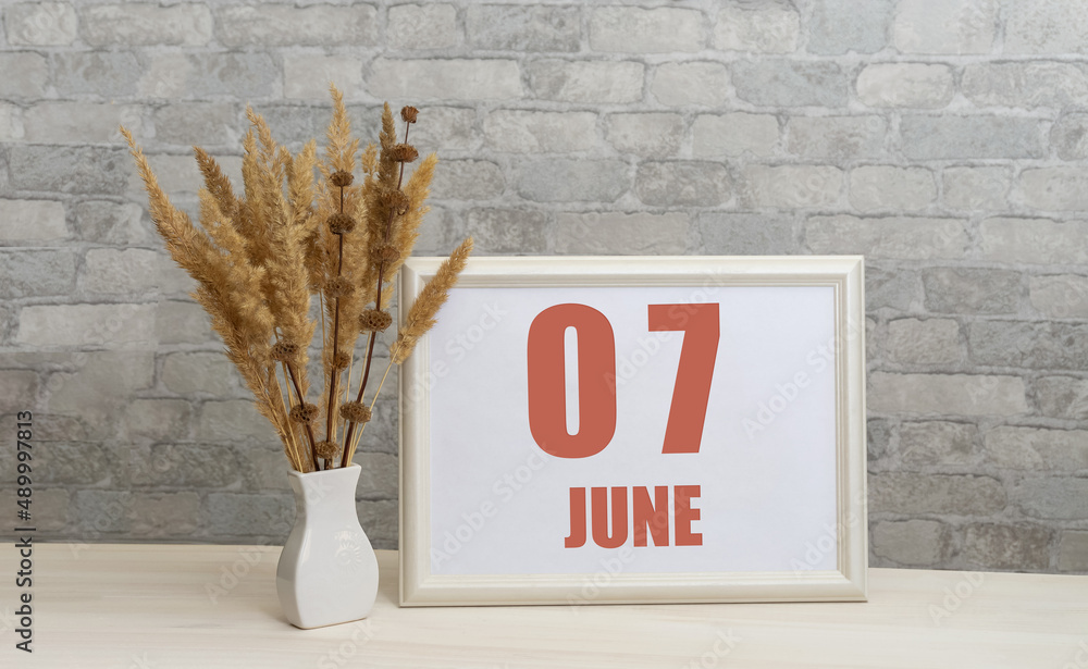 june 7. 7th day of month, calendar date. White vase with ikebana and ...