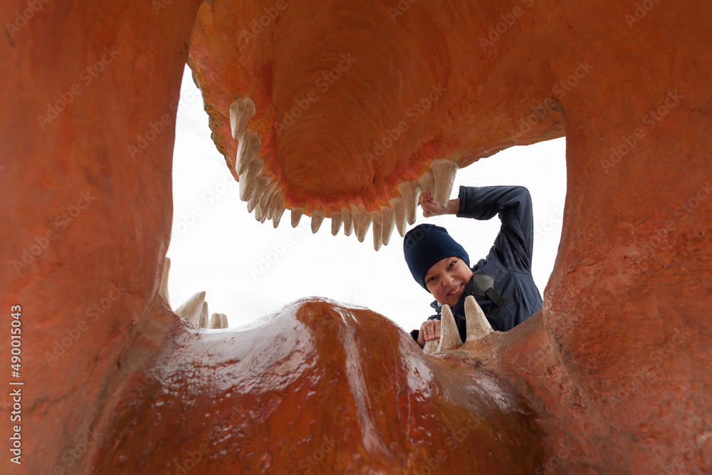 the guy opens the mouth of a monster with large and sharp teeth. inside ...