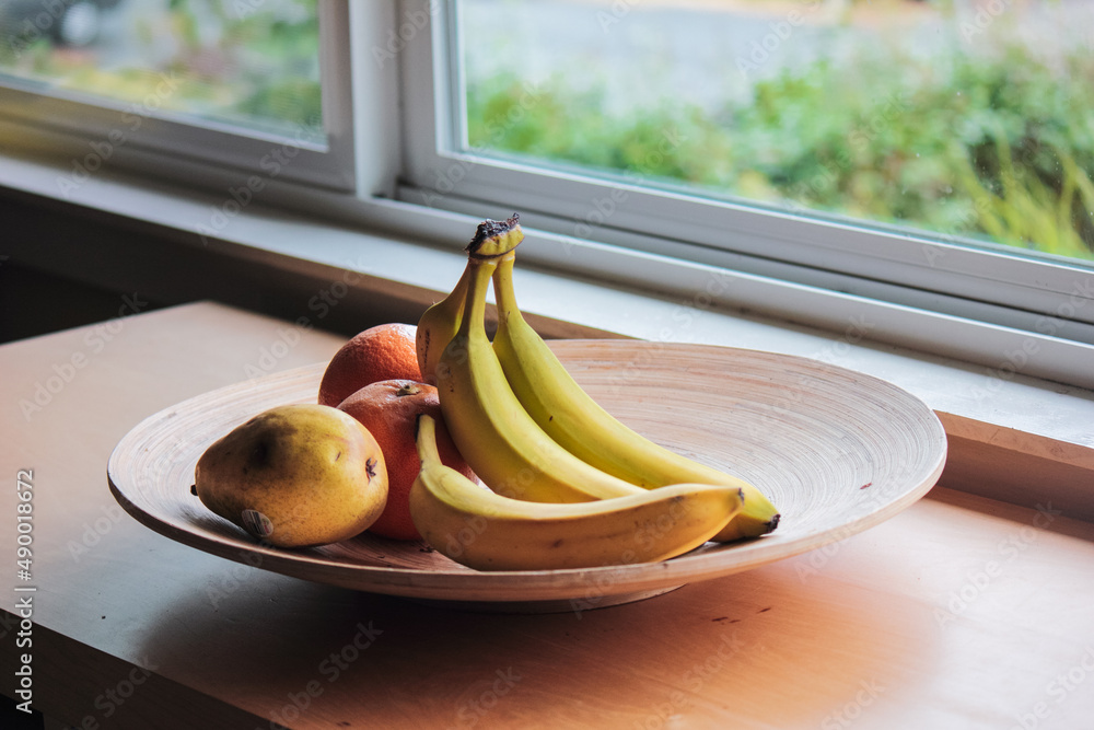 Still life with fruits next to window Stock Photo | Adobe Stock
