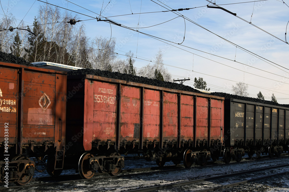 Freight wagons with coal at the railway station. Loading wagons for ...