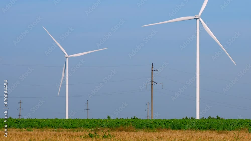 Wind driven generators produce alternative energy in field. Modern ...