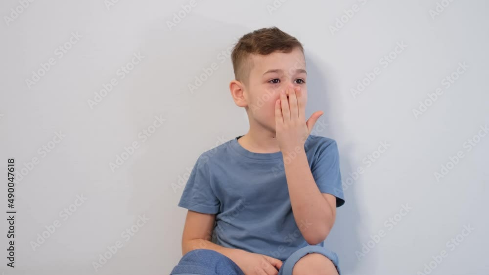 Bad breath. Halitosis concept. Child checking his breath with his hand ...
