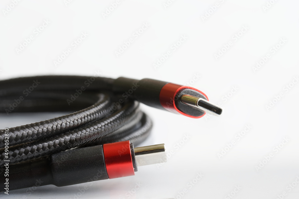 Two red-black usb type-c connectors and a black reinforced braided wire ...