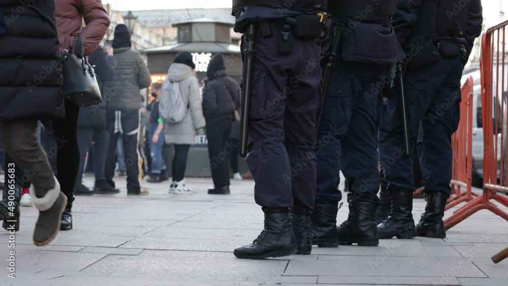 police officers in uniforms with batons and pistols at a rally against ...