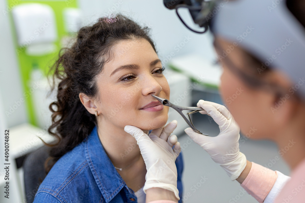 Otolaryngology concept. Positive woman otorhinolaryngologist checking ...