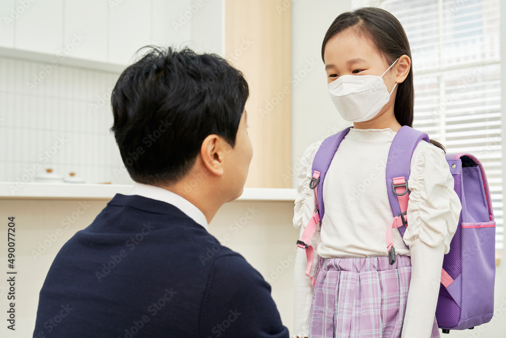 Elementary school children wearing school uniforms and masks and their ...