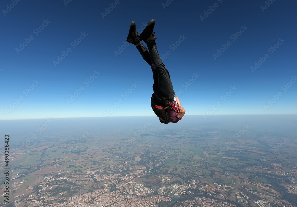 Parachutist performing a maneuver in a stretched body in free fall ...
