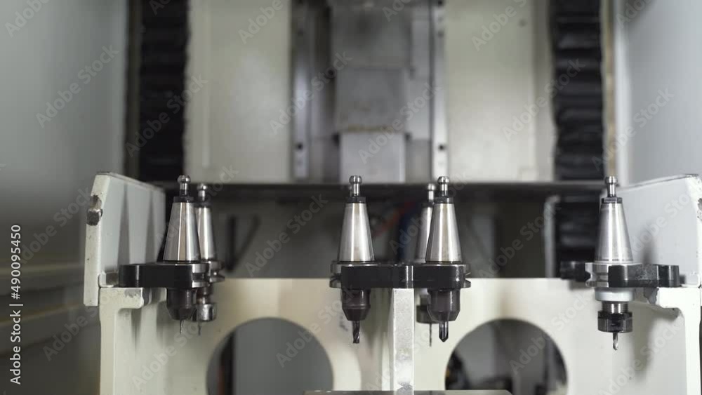 CNC machine detaching an ejectable drill, putting it into a tool rack ...