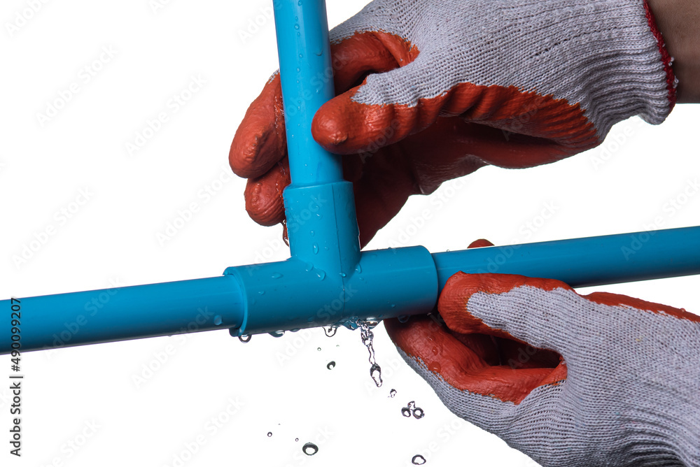 Man's hand holding blue pvc plastic pipe with a broken connection and ...