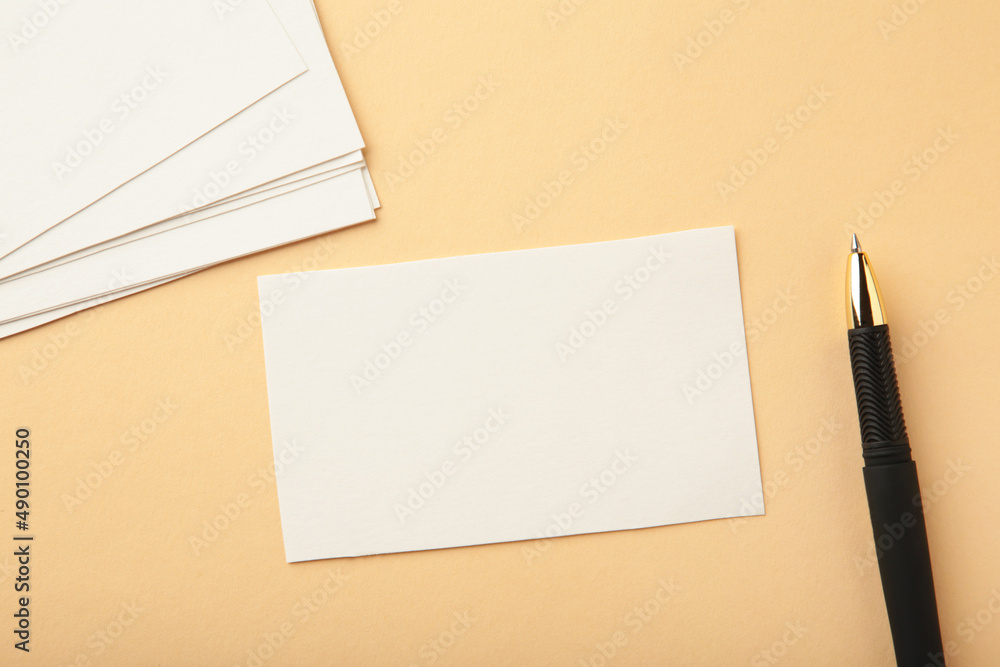 Blank white business cards on beige paper background. Mockup for ...