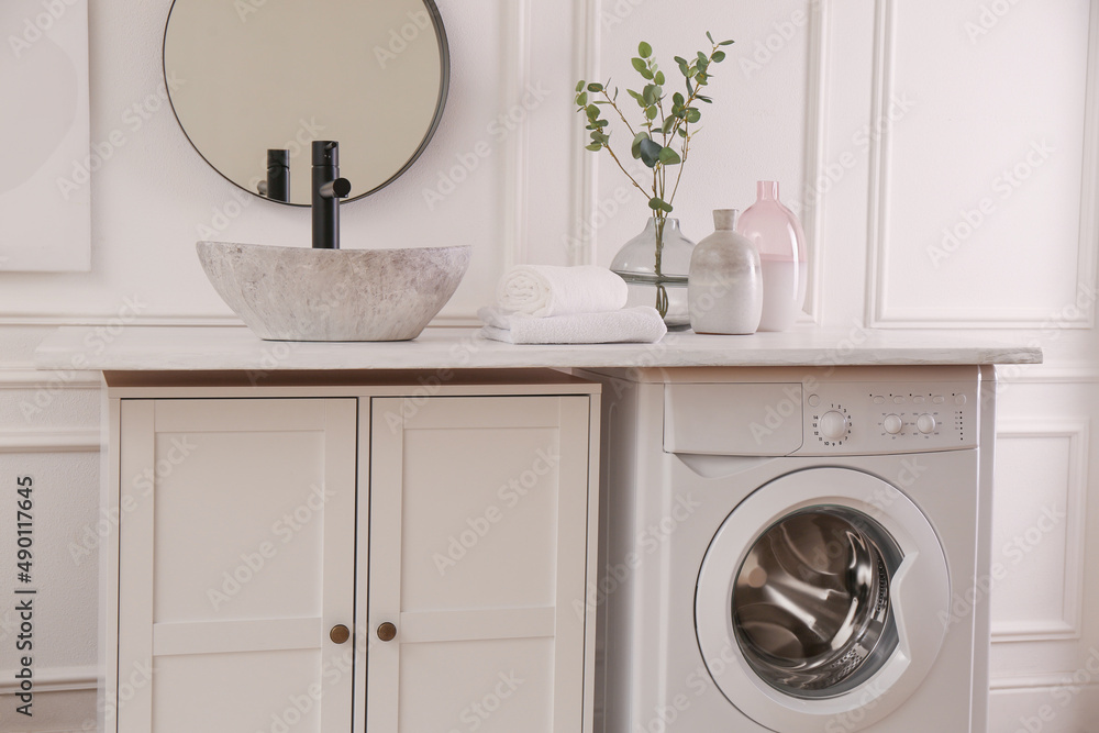 Laundry room interior with modern washing machine and stylish vessel ...
