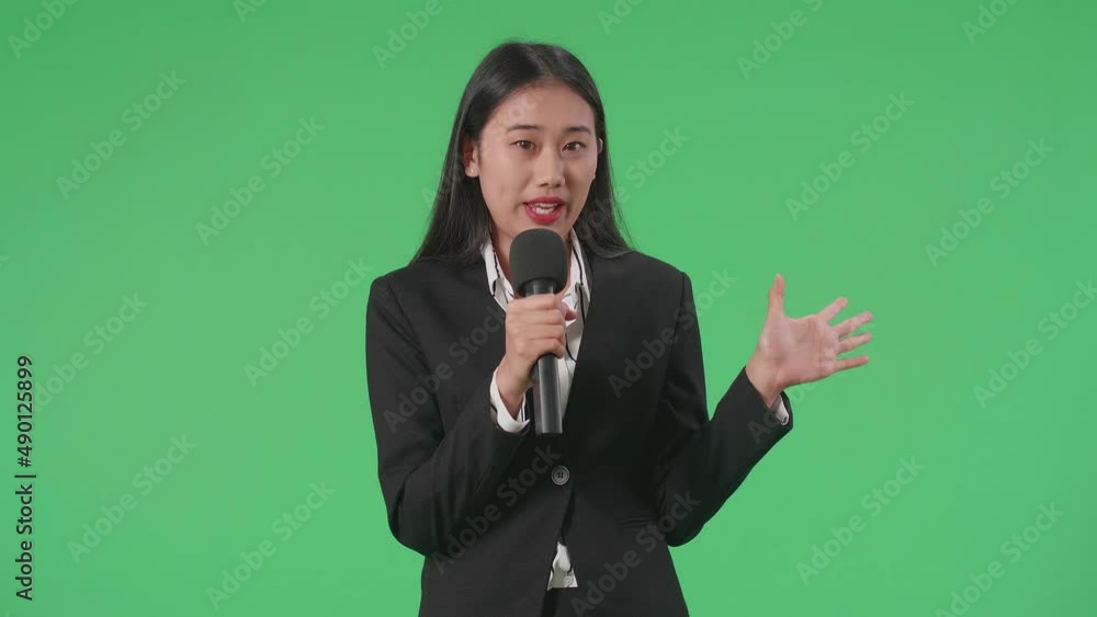 Asian Woman Journalist Pointing On Something While Speaking Into A ...