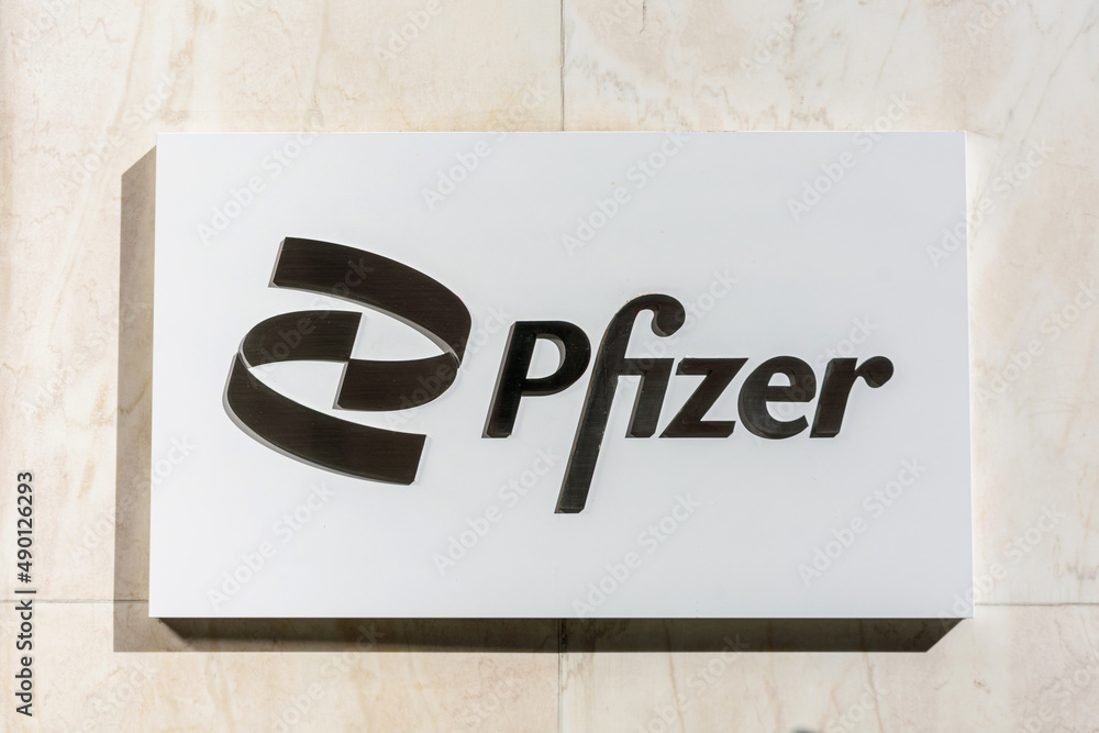 Pfizer sign, logo on the facade of pharmaceutical and biotechnology ...