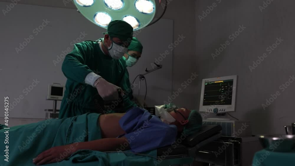 Hands of doctor holding defibrillator electrods, performing ...