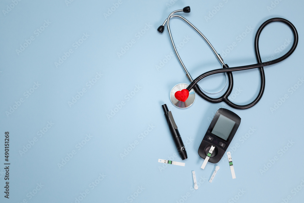 Diabetes equipment, glucose level blood test on blue background with ...