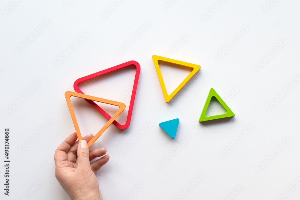 Hand with triangle. Nested wood triangles, concentric educational ...