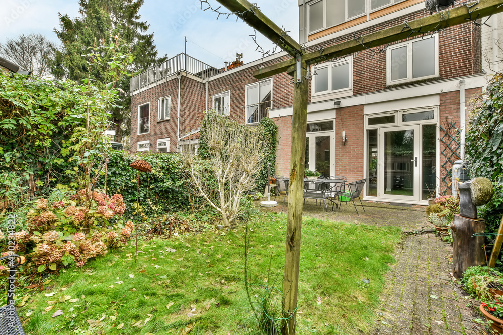 Large house with a garden in the backyard Stock Photo | Adobe Stock