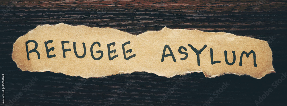 pieces of paper with words Refugee and Asylum message for help people ...