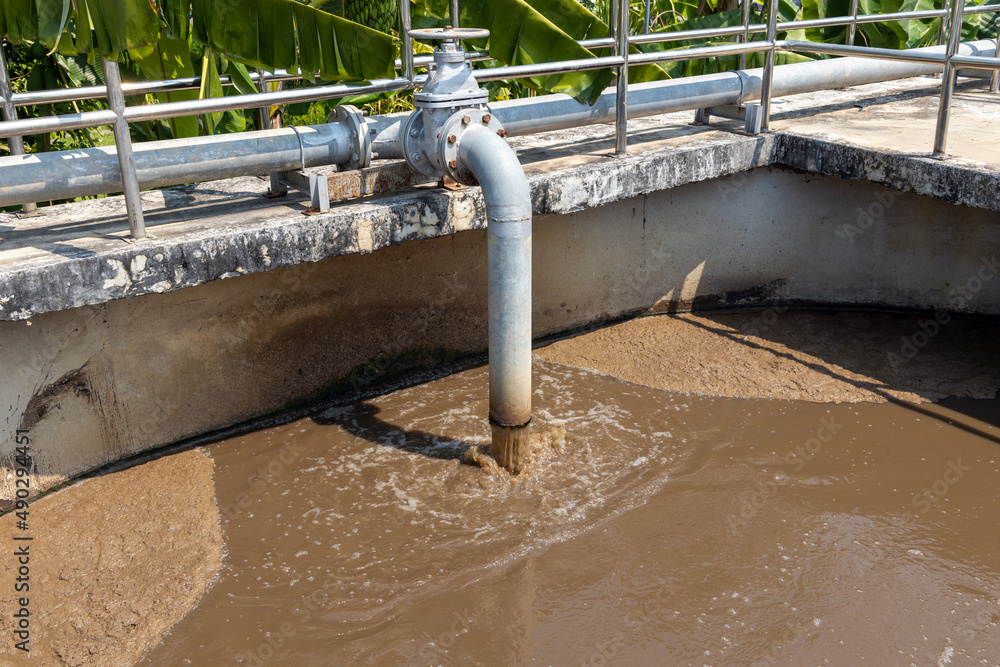 Sewage from drainpipe factory or city flowing to tank for aeration and ...