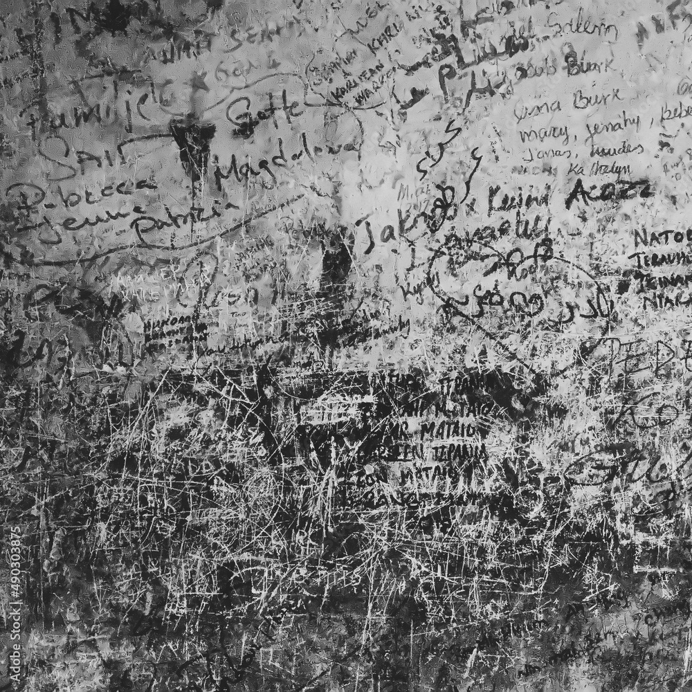 Texture of old wall with inscriptions. Text on the wall in a black and ...