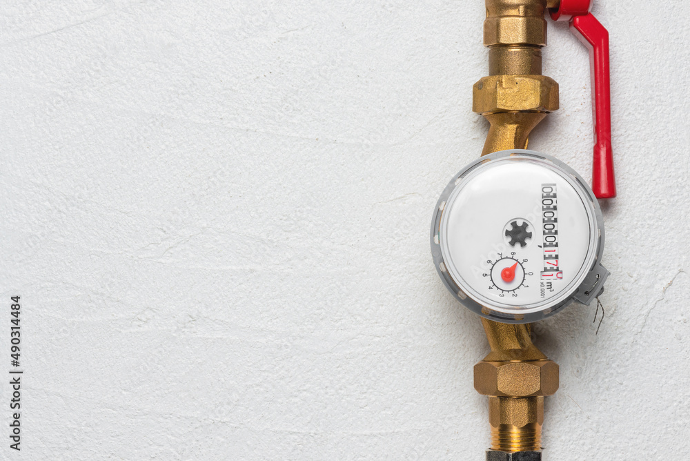 Water meter on the white flat lay close up background with copy space ...