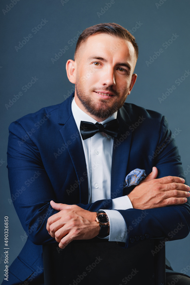 Caucasian man of 30-35 years old in business classic suit sits on chair ...