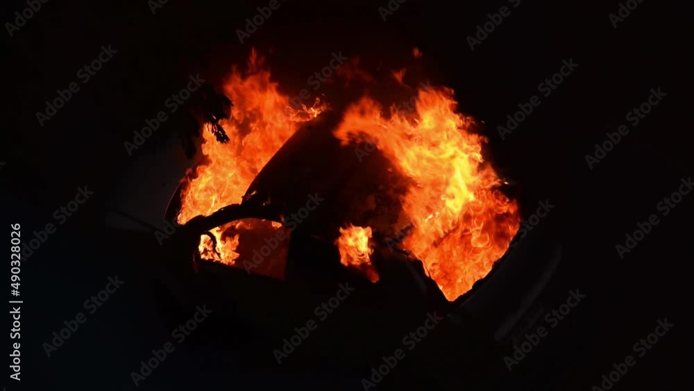 Car burning in fire explosion blast during war attack at night. Stock ...