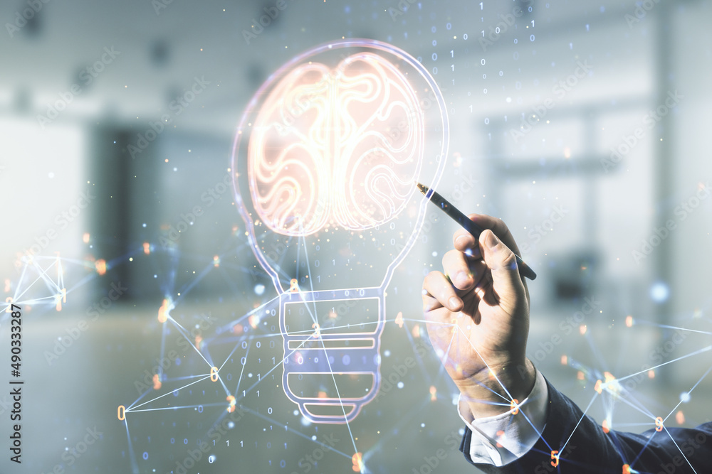 Man hand with pen draws abstract virtual idea concept with light bulb ...