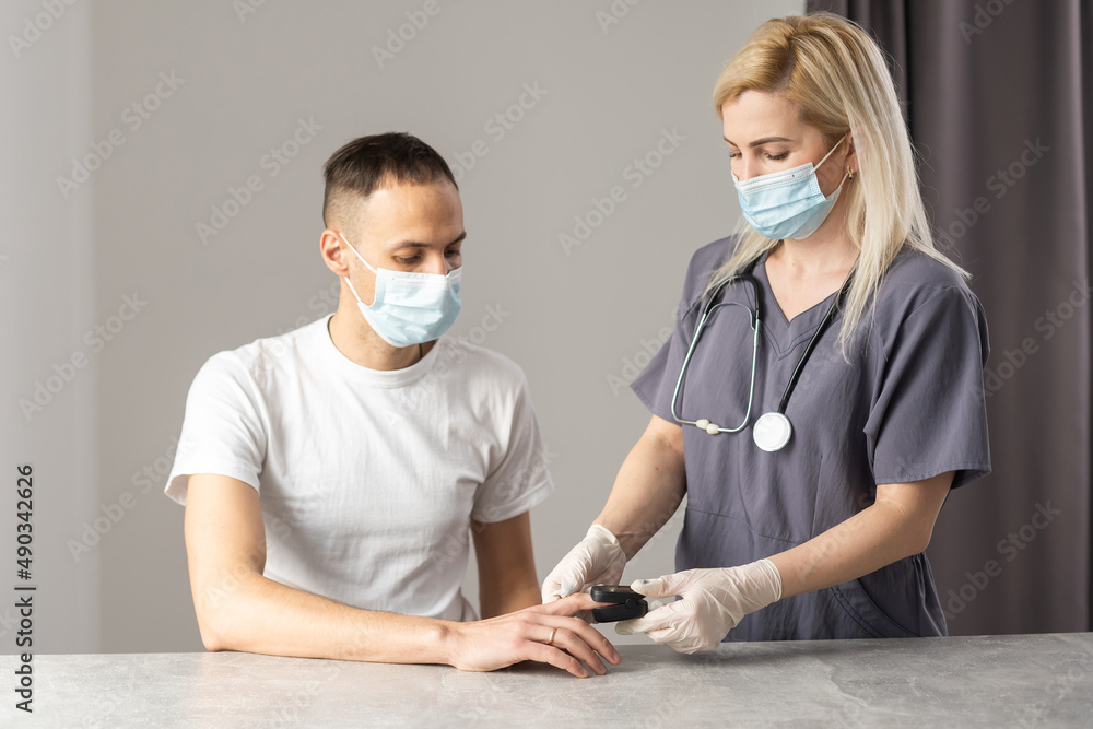 Doctor checking oxygenation with fingertip pulse oximeter. Saturation ...