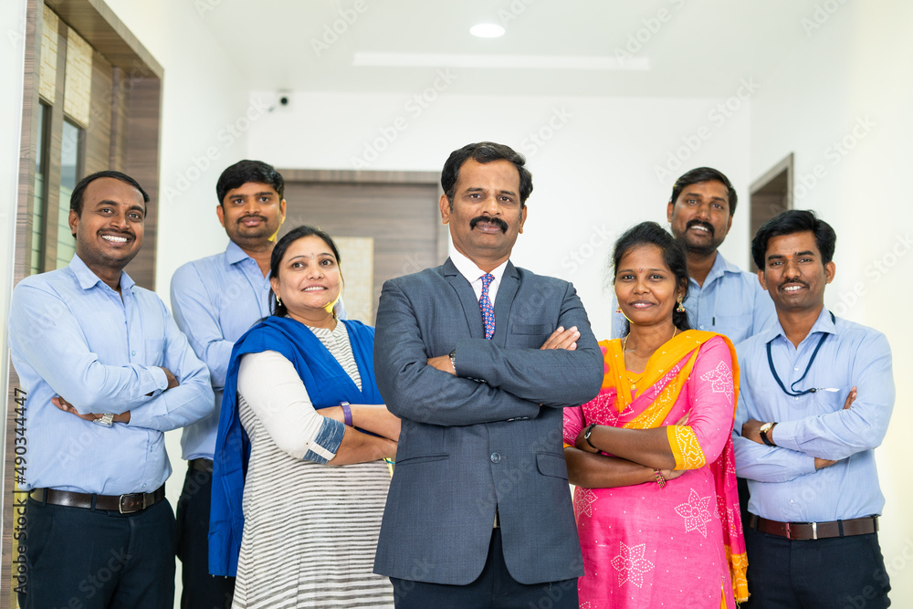 Diverse Indian corporate employees with arms crossed standing looking ...