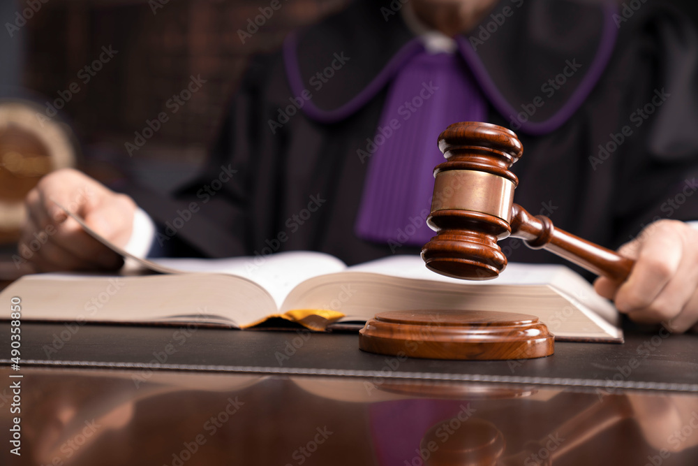Law and justice – judge in toga with the gavel during trial Stock Photo ...