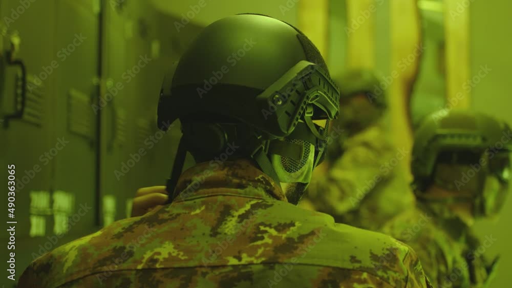 Group of Soldiers or Special Forces preparing for a fight in a military ...