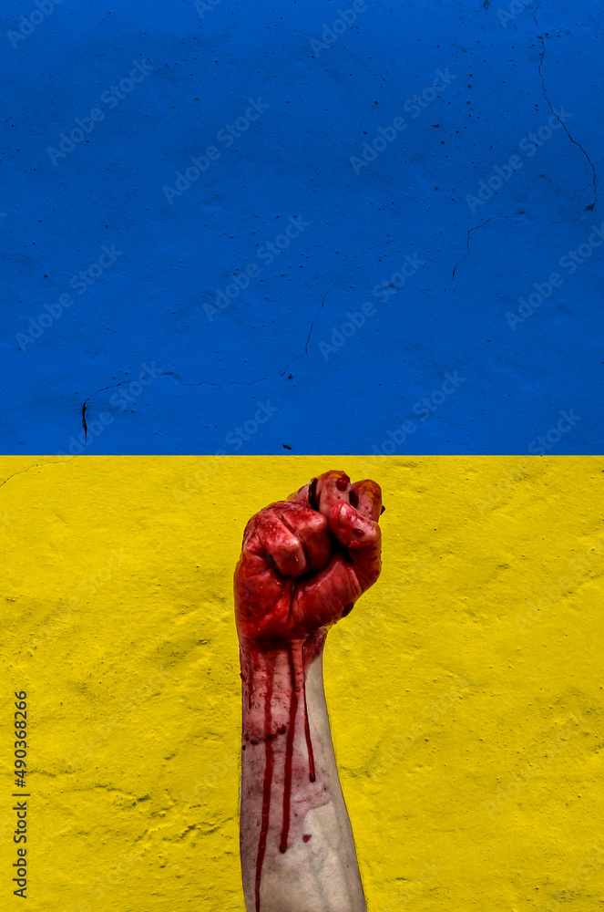 Wounded hand with the raised fist with Ukrainian flag colours as a sign ...