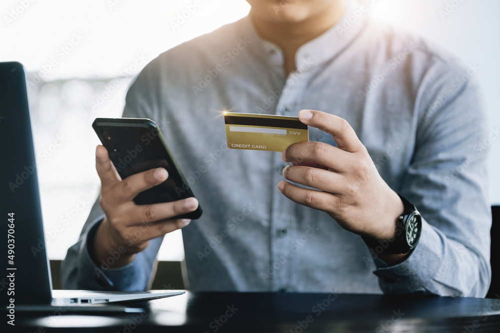 Online Shopping and Internet Payments, Asian man are using their credit ...