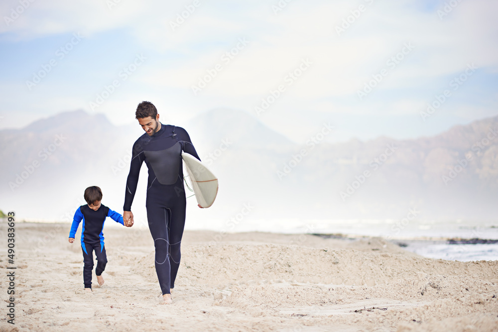 Sharing a passion for surfing with his son. Shjot of a father and son ...