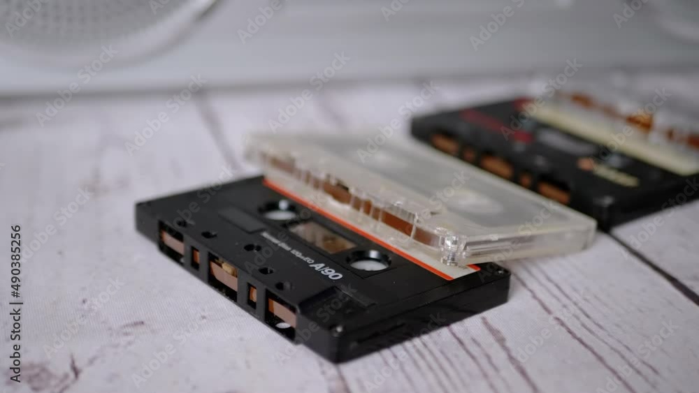 Lots of Falling Audio Cassettes on Table Domino Effect. A pile, a stack ...