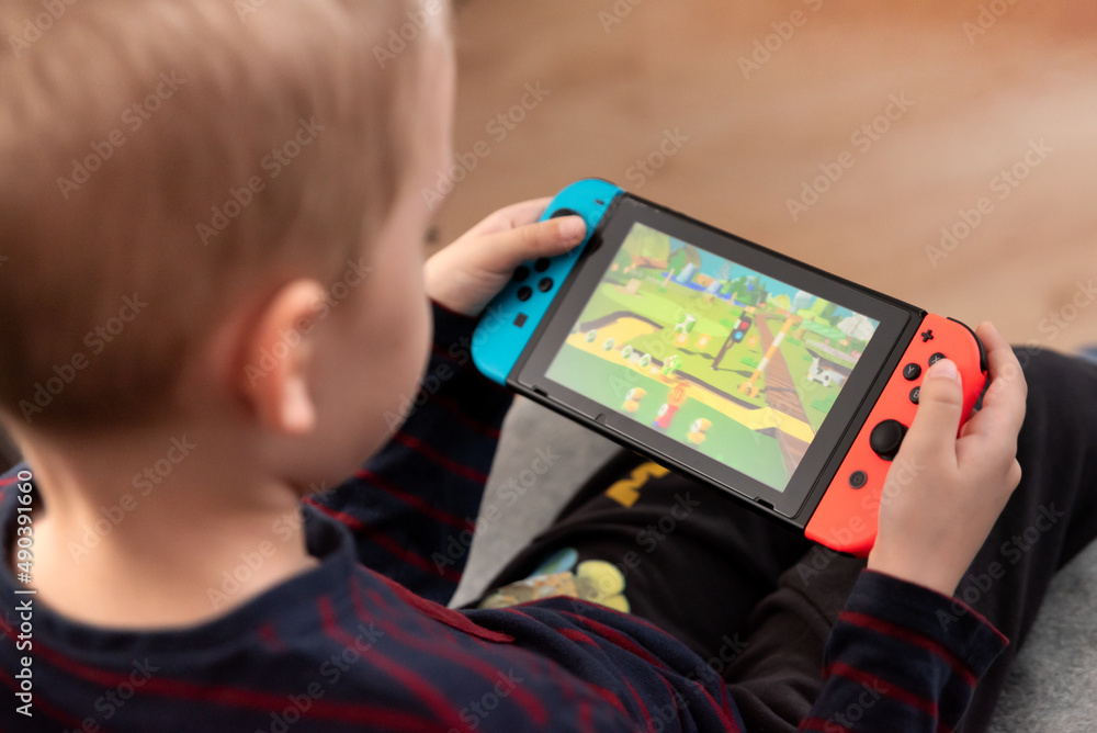 Boy plays Nintendo Switch console Stock Photo | Adobe Stock