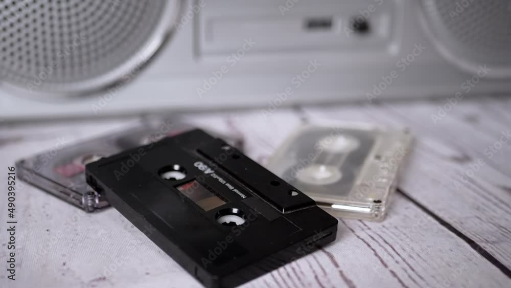 Female Hands Throwing an Old Black Audio Cassette on Table. Trash. A ...