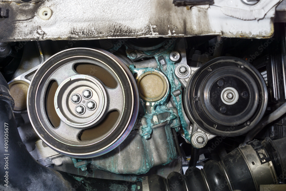 Car parked with water coolant liquid has stains from leaks on engine ...