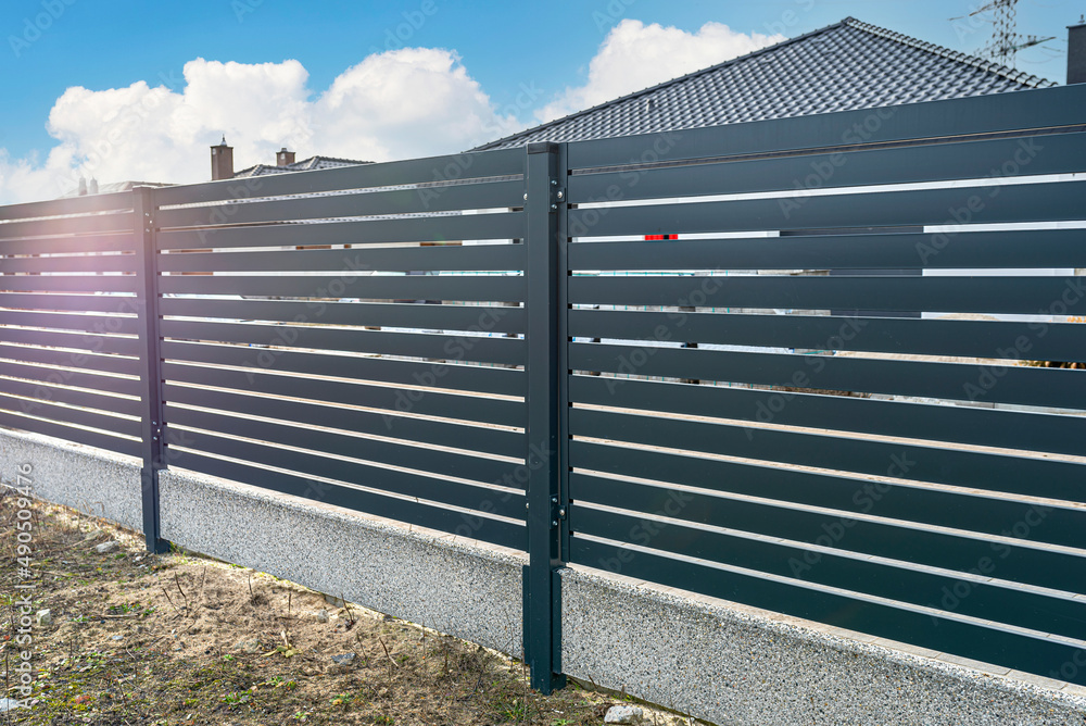 Modern anthracite panel fencing, visible spans and a fence foundation ...