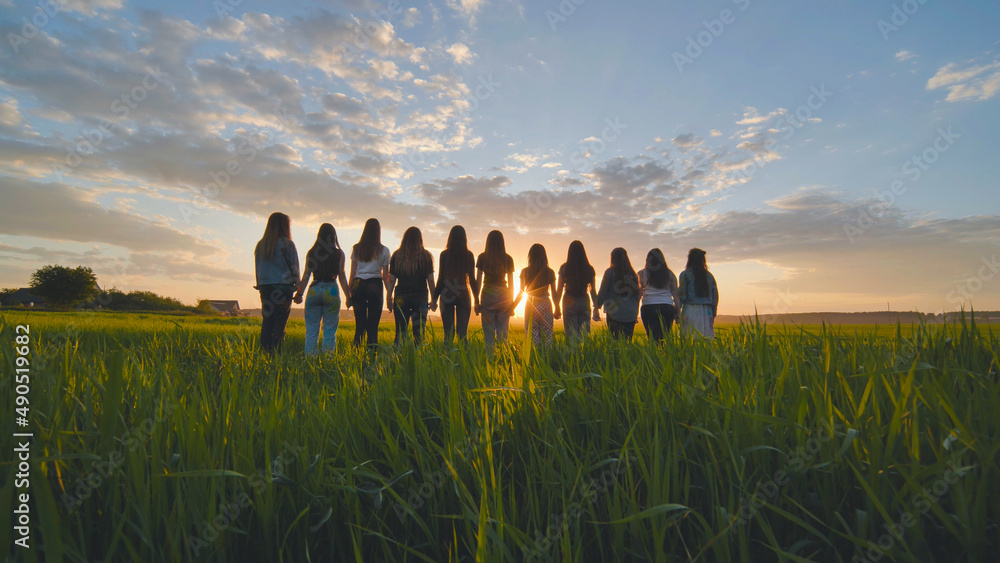 Group Holding Hands Sunset