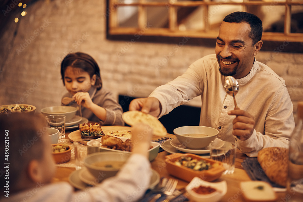 Happy Muslim father gives his son Lafah Bread during dinner at dining ...