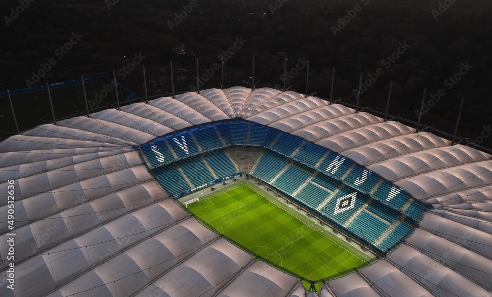 Aerial night view over the illuminated Volksparkstadion, home stadium ...