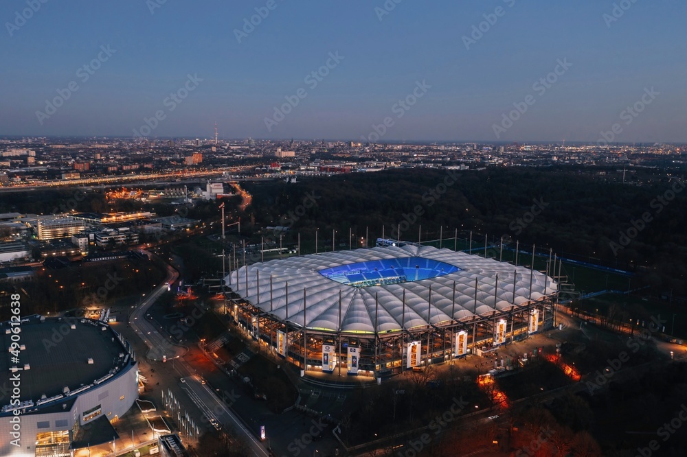 Aerial night view over the illuminated Volksparkstadion, home stadium ...