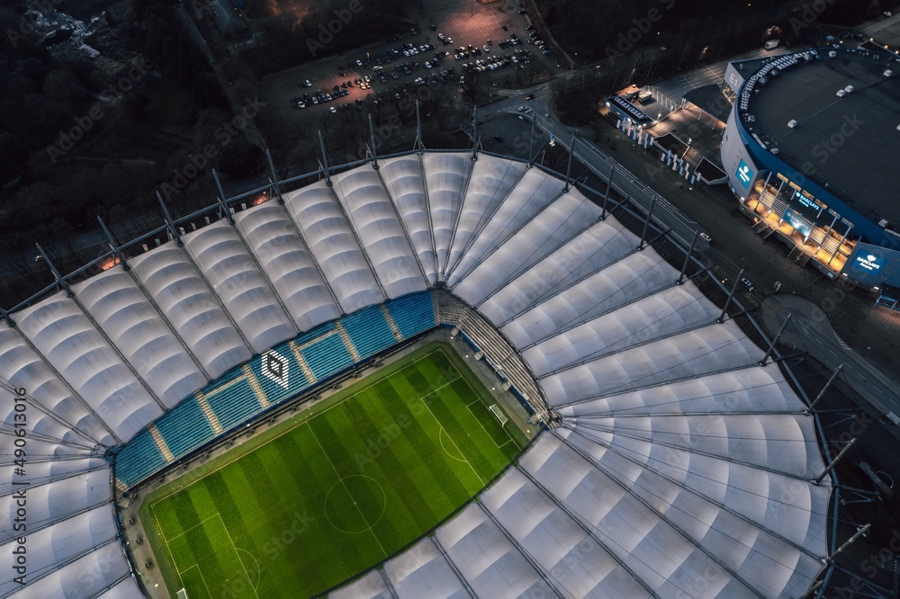 Aerial night view over the illuminated Volksparkstadion, home stadium ...