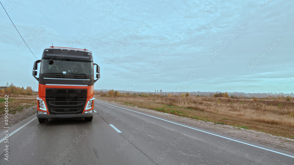 Front Side view of truck with cargo trailer driving alone on multilane ...