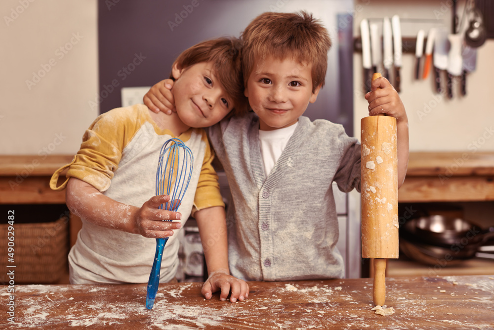 We bake as a team. Cropped shot of two young brothers baking in the ...